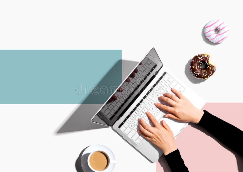Person Using a Laptop Computer with a Donut and a Cup of Coffee Stock ...