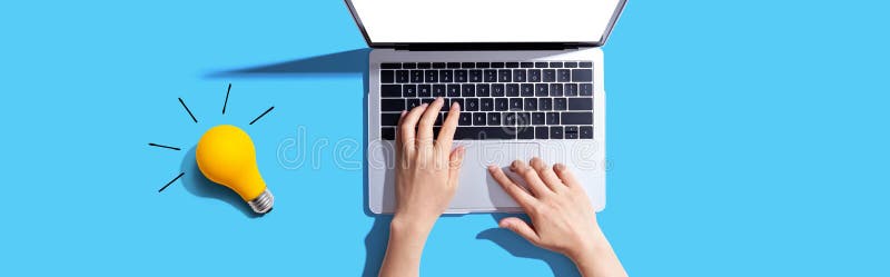 Person Using a Laptop Computer and a Light Bulb Stock Photo - Image of ...