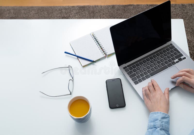 Person Using a Laptop Computer on the Modern White Office Desk Table ...