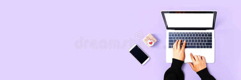 Person Using a Laptop Computer with a Small Gift Box Stock Photo ...