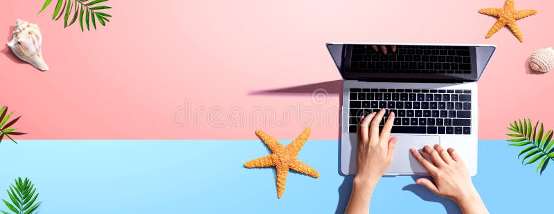 Person Using a Laptop Computer with Summer Theme Objects Stock Photo ...