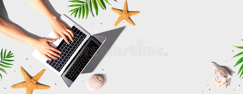 Person Using a Laptop Computer with Summer Theme Objects Stock Photo ...