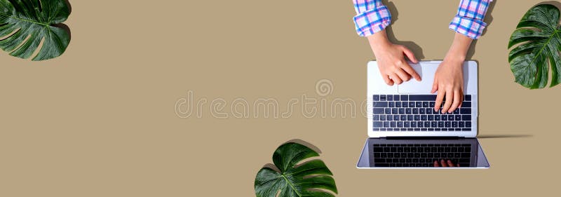 Person Using a Laptop Computer with Tropical Leaves Stock Image - Image ...