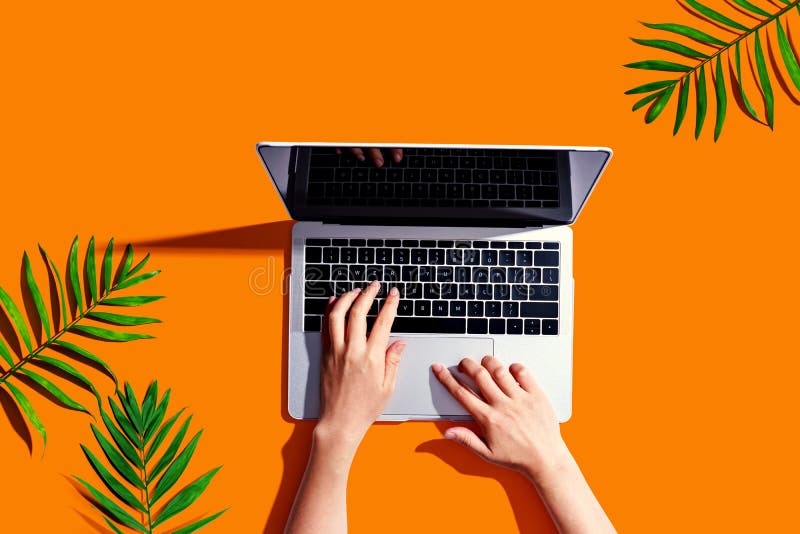 Person Using a Laptop Computer with Tropical Leaves Stock Image - Image ...