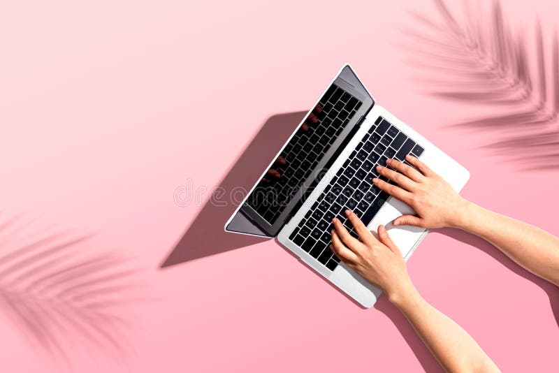 Person Using a Laptop Computer with Tropical Plant Shadow Stock Photo ...