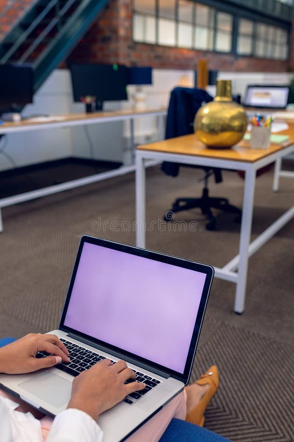 Person Using Laptop in Modern Office, Focusing on Work with ...