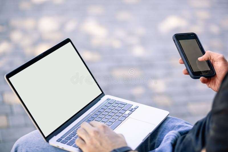 A Person Using a Laptop and a Smartphone Simultaneously while Sitting ...