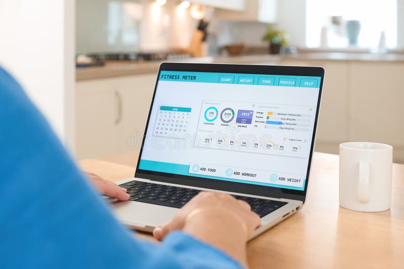 Person Using Laptop To Track Fitness Progress in Modern Kitchen Setting ...
