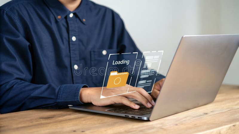 Person Using a Laptop with a Loading Icon Overlayed on the Screen on a ...