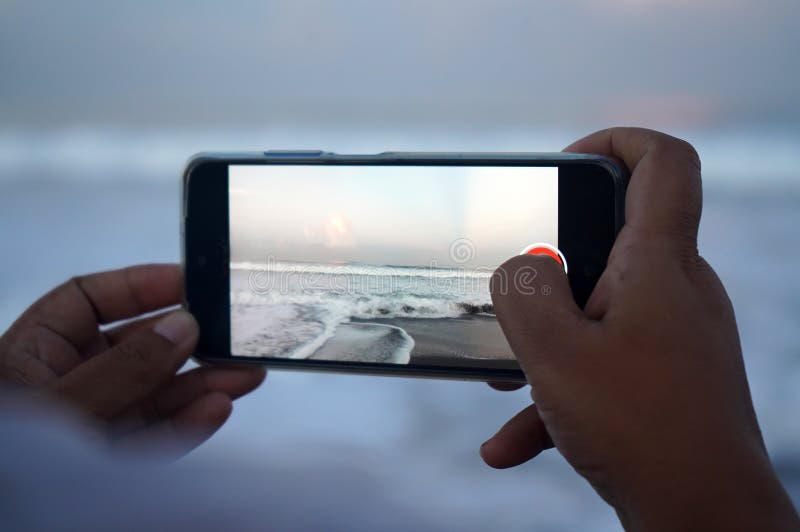 Person Using Phone. Person Capturing Beach Landscape by Cellphone in ...
