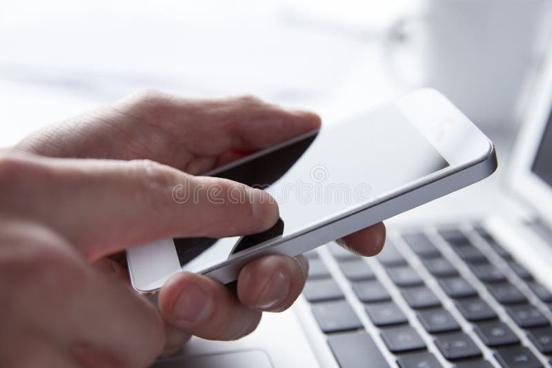 Person Using Phone while Working on a Laptop Stock Image - Image of ...