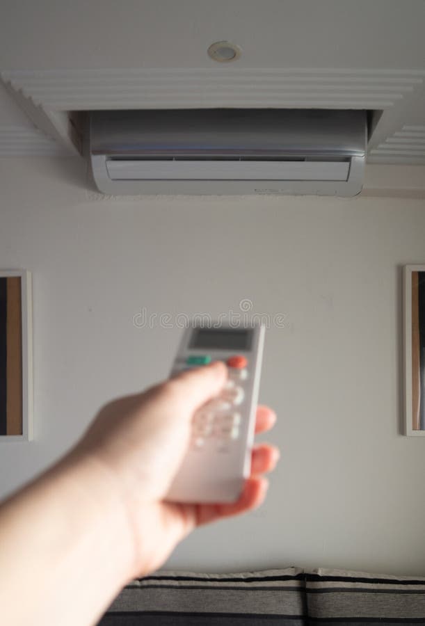 Person Using Remote Control To Turn on Air Conditioner Stock Image ...