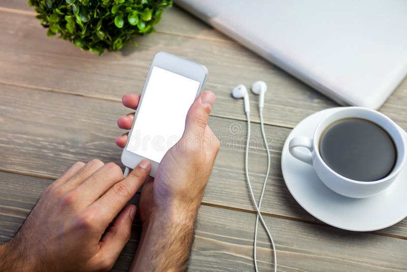 Person Using Smart Next To Coffee Mug at Desk Stock Photo - Image of ...