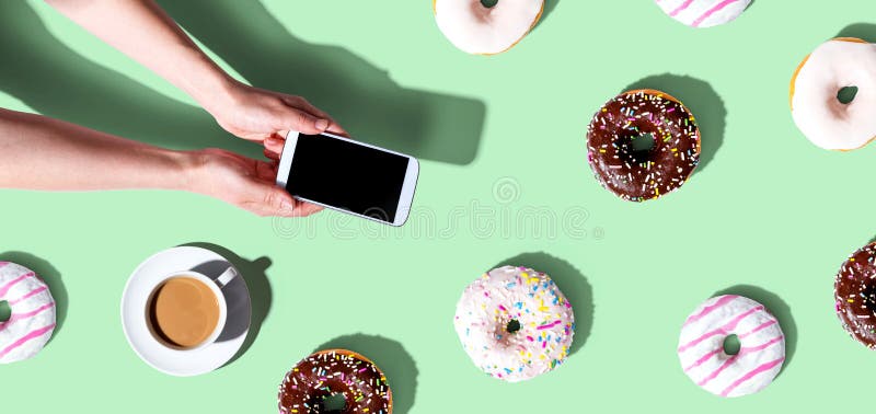 Person Using a Smartphone with Donuts Stock Photo - Image of flatlay ...