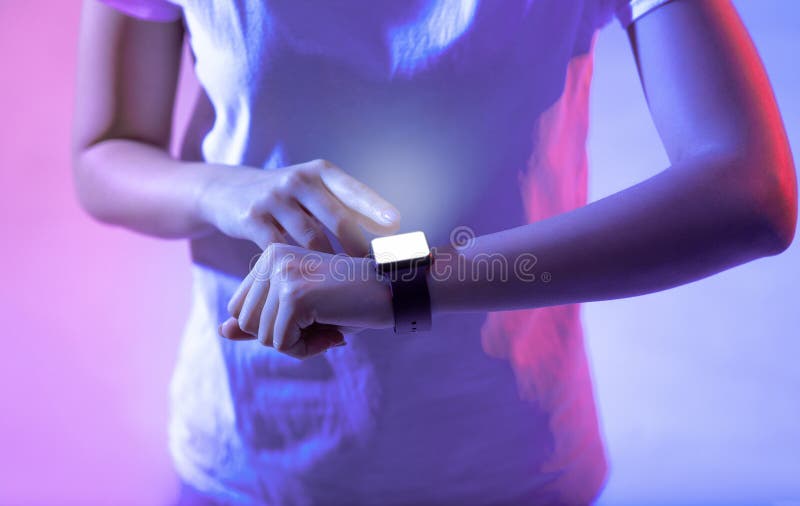 Person Interacts with Smartwatch Under Colorful Lighting at Home Stock ...