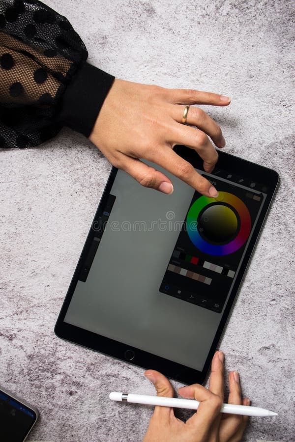 Person Using a Tablet with a Color Wheel on Screen, Showcasing Digital ...
