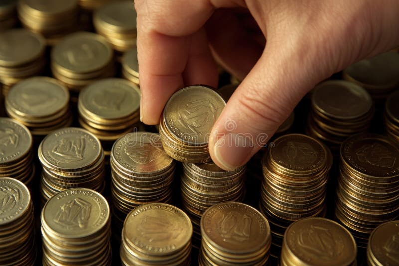 A Person is Using Their Finger To Point at a Large Stack of Coins Stock ...