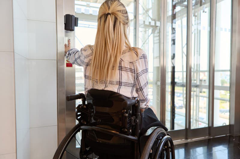 Independent Woman in Wheelchair Accessing Elevator in Modern Building ...