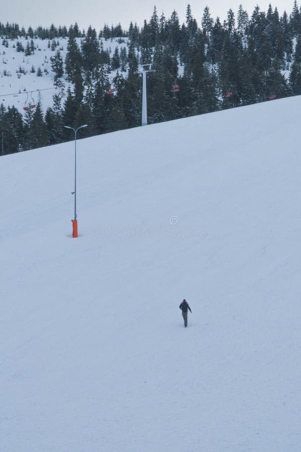 Person Walking Down a Snow-covered Slope Stock Image - Image of high ...