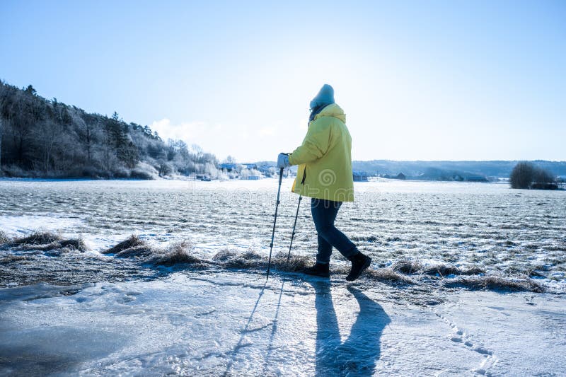 Person Walking on Ice with Spikes and Walking Poles.. Stock Image ...