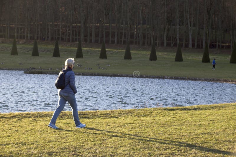 Person walking in the park editorial photo. Image of person - 251599411