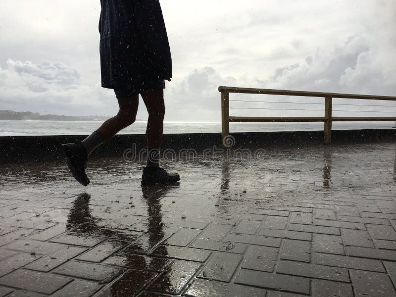 Person Walking, Rain Falling on Pavement Stock Photo - Image of storm ...