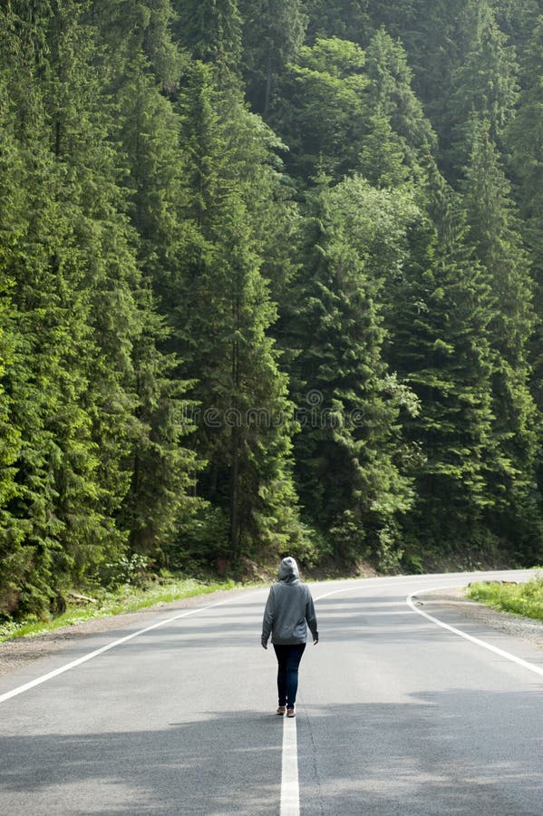 Person Walking On Road Near Trees Picture. Image: 119467614