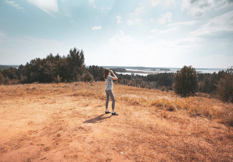 Person Watching Nature Landscapes through Binoculars. Hiker in Field ...
