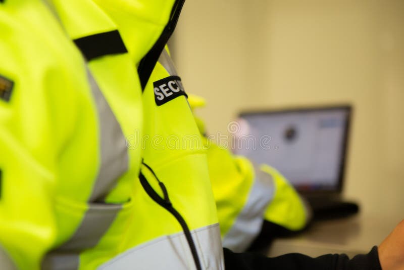 Person Wearing a Yellow Security Jacket Uniform at the Work, Close-up ...