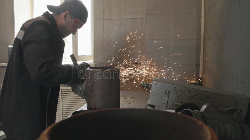 Video 4k. Industrial Worker Grinding a Large Metal Pipe Inside a Tool ...