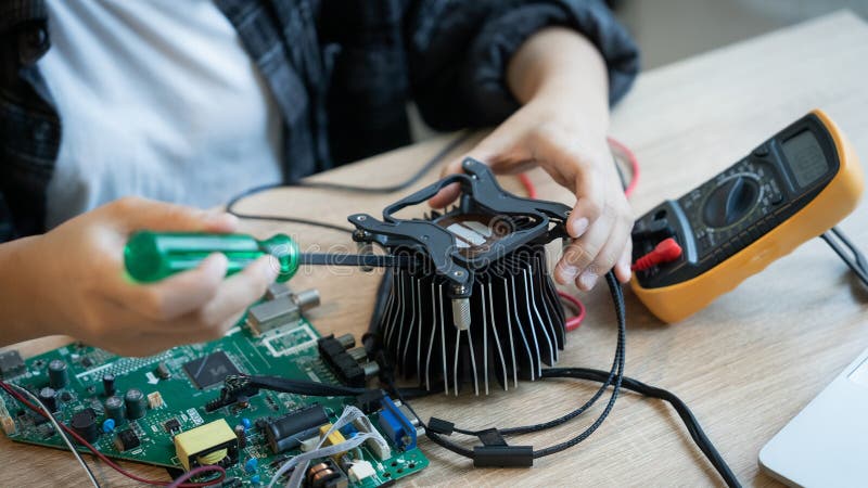 A Person is Working on a Computer Part, Possibly a CPU. the Person is ...