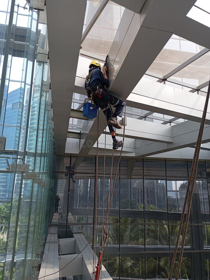 A Person is Working at Height Using Rope Access Stock Image - Image of ...