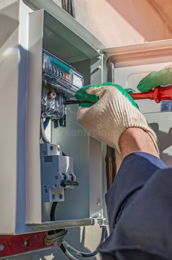 A Person Working on the Installation of Electrical Meter Equipment ...