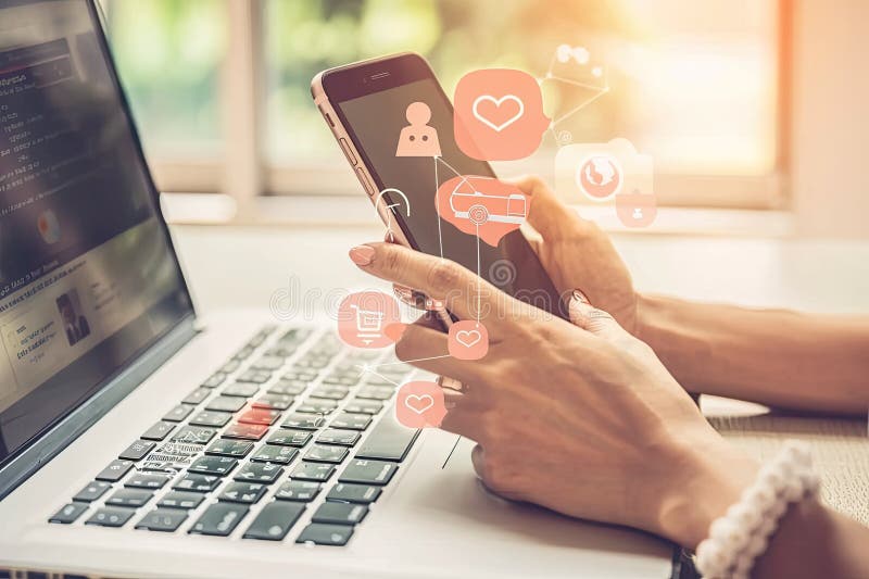 A Person is Working on a Laptop Computer with a Cell Phone Nearby Stock ...