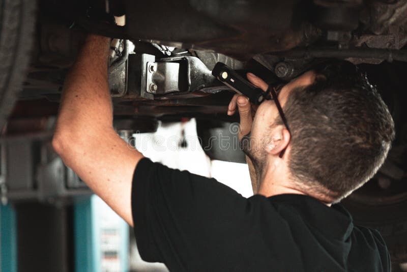 Person Working Under a Car and Repairing Stock Image - Image of ...