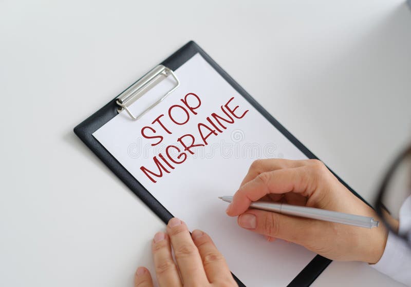 A Person is Writing on a Clipboard with the Words Stop Migraine Written ...