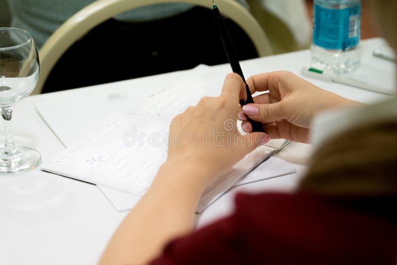 Person writing in notepad stock image. Image of conference - 114460309