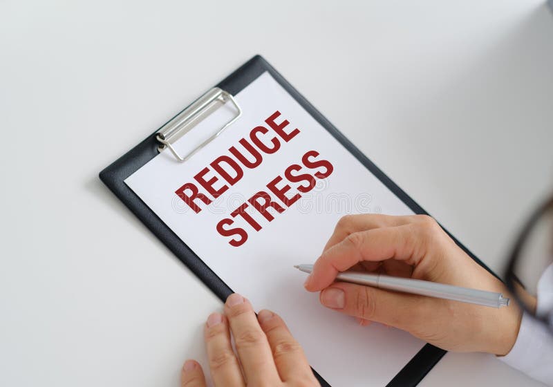 A Person is Writing the Word "reduce" on a Clipboard Stock Photo ...