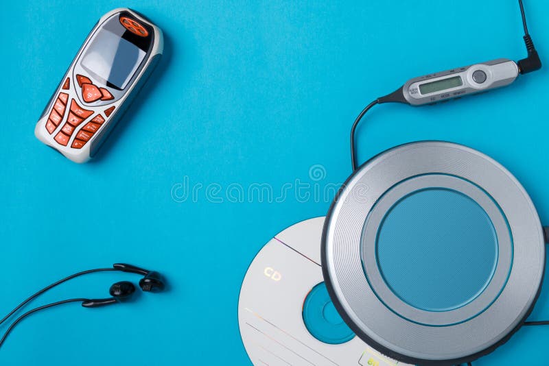 Personal Cd Player with Remote Control and Mobile Phone on Blue ...