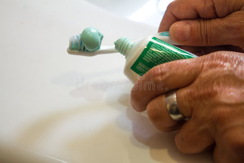 Personal Hygiene with Hands Squeezing Toothpaste on the Toothbrush ...