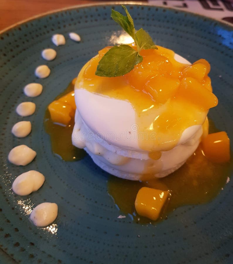 Personal Pavlova Cake with Mango Syrup and Mint Leaf. Stock Photo ...