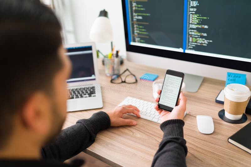 Software Developer is Coding on His Smartphone and Computer Stock Photo ...