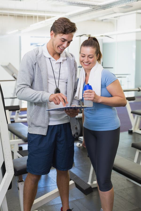 Personal Trainer and Client Looking at Clipboard Together Stock Image ...