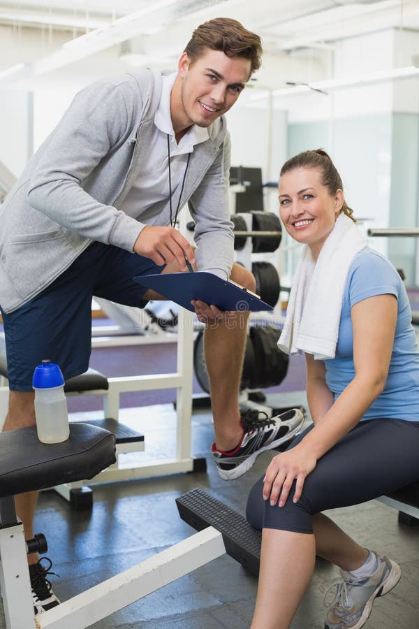 Personal Trainer and Client Looking at Clipboard Together Stock Image ...
