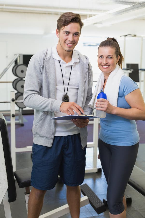 Personal Trainer and Client Smiling at Camera Stock Photo - Image of ...