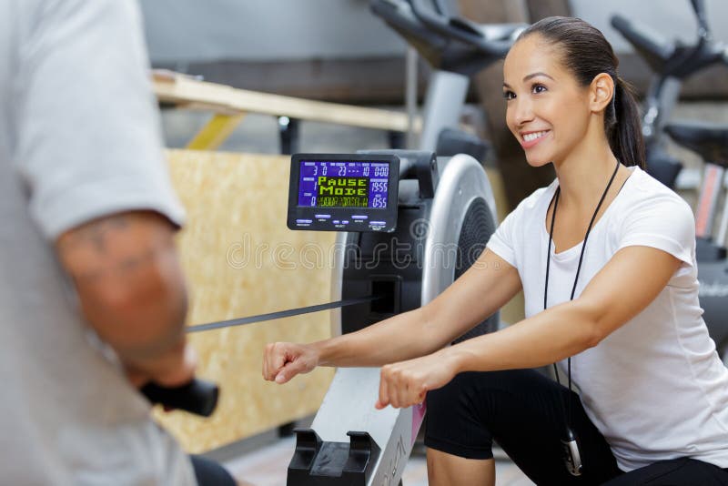 Personal Trainer Demonstrating Technique for Gym Equipment Stock Photo ...