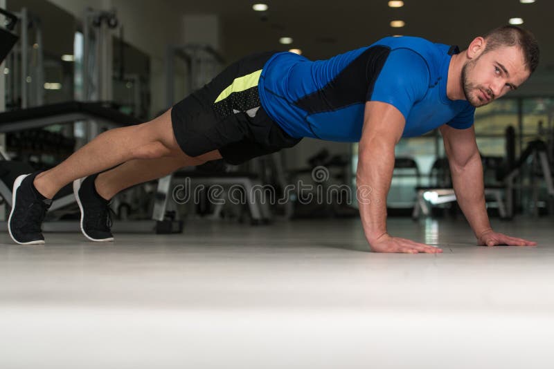 Personal Trainer Doing Push-ups on Floor in Gym Stock Photo - Image of ...