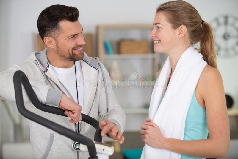 Personal Trainer Explaining Settings on Exercise Machine Stock Image ...