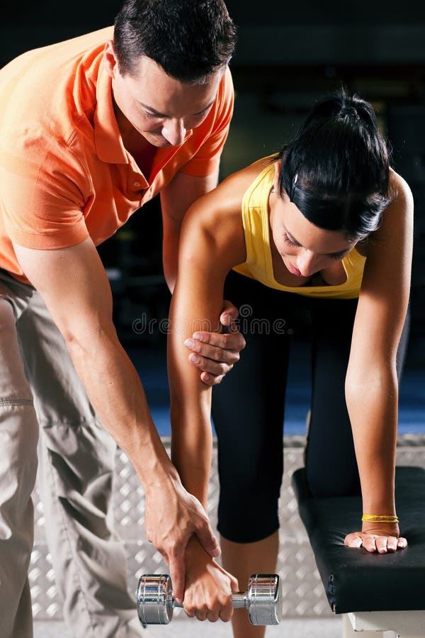Personal Trainer in gym stock image. Image of powerful - 12409537