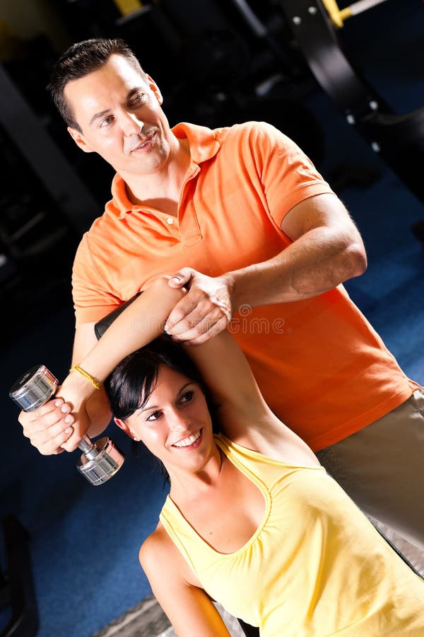 Personal Trainer in gym stock image. Image of dumbbells - 15235911